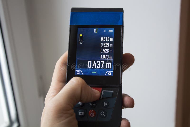 Man& X27;s Hand with a Digital Rangefinder Measures the Distance Stock ...