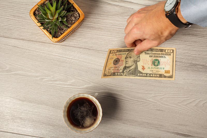 Man& X27;s Hand Gives a 10 Dollar Bill in Payment for a Cup of Coffee ...