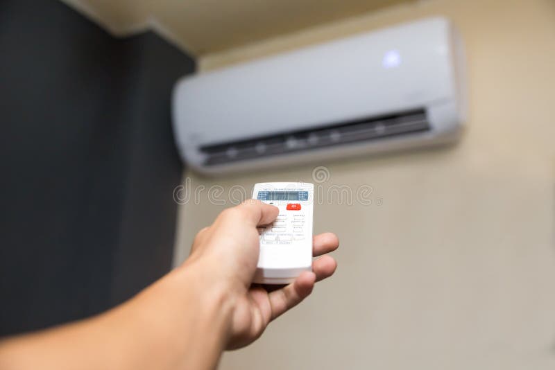 Man`s Hand Holding Air Conditioning Unit Remote Control Stock Photo ...