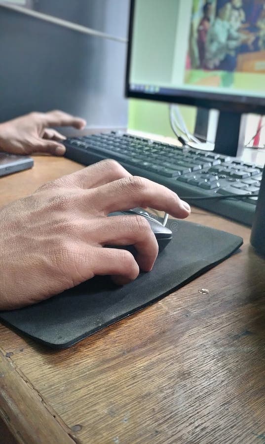 Man& X27;s Hand Holding a Mouse Working Front of Computer Stock Photo ...