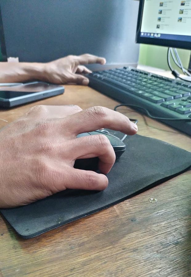 Man& X27;s Hand Holding a Mouse Working Front of Computer Stock Image ...