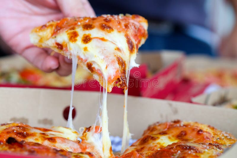 Man s hand holding a pizza stock photo. Image of gourmet - 74479636