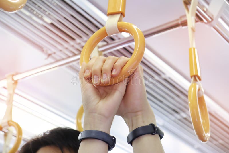 Man`s Hand Holding a Woman`s Hand on Circle Handle on the Train during ...