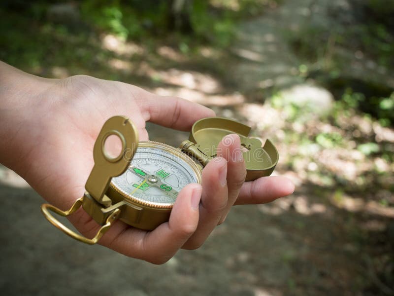 A Man`s Hand Holds a Compass Stock Image - Image of arrow, nature: 94143445