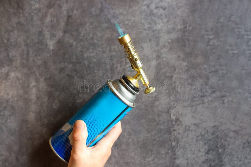 Man S Hand Holds a Cylinder with a Lit Gas Burner for Ignition Stock ...