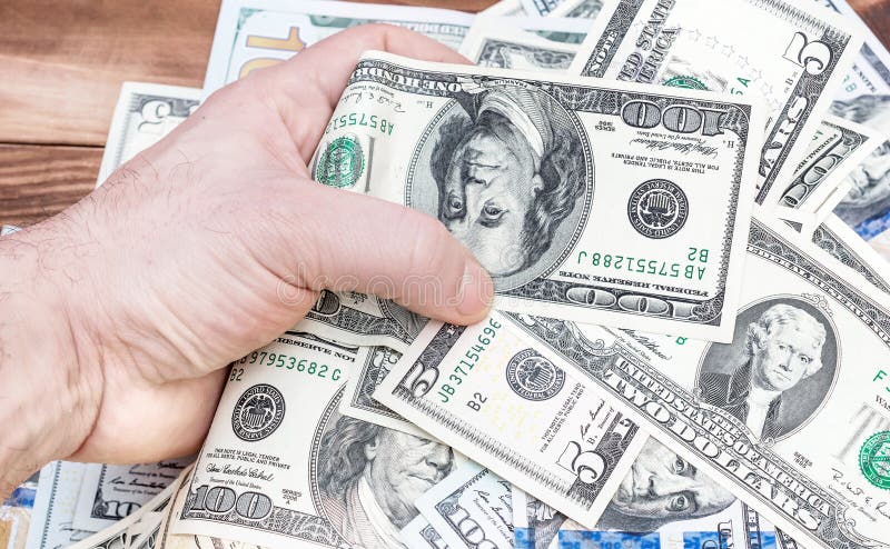 Man S Hand Holds Dollar Bills Over Table with Money Stock Photo - Image ...