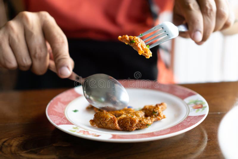 Man`s Hand Holds a Spoon, is Scooping Food on a Plate, Eating Food ...