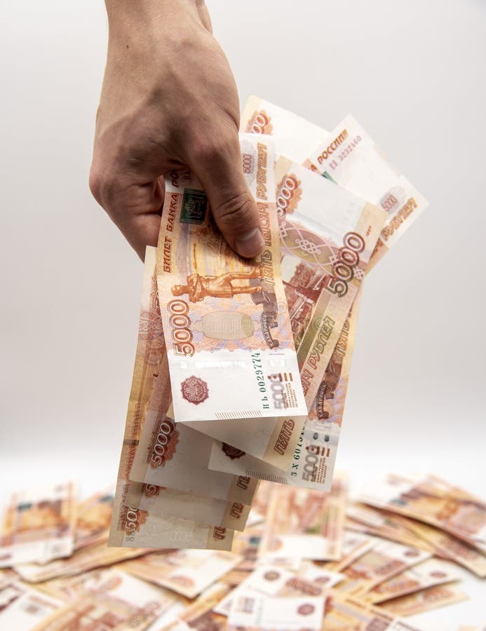 A Man`s Hand Holds a Bundle of Five Thousand Ruble Bills. Stock Photo ...
