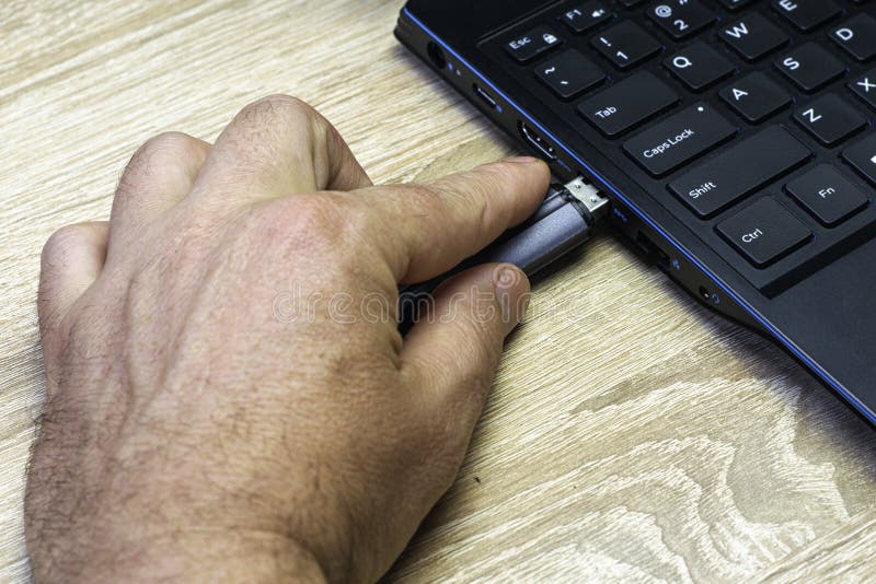 A Man`s Hand Inserting a Flash Card into the Laptop Connector Stock ...