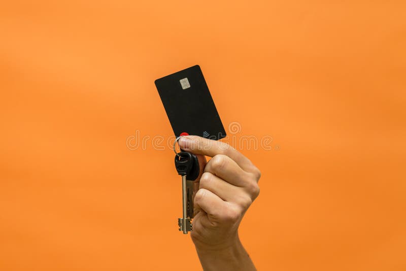 Man S Hand with Keys and Credit Card Isolated on Orange Background ...