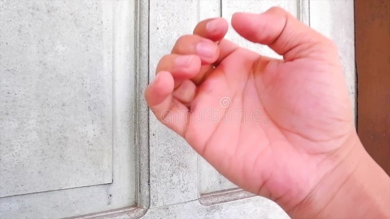 A Man S Hand Knocks on a Door, with Sunlight Shining on Its Surface ...