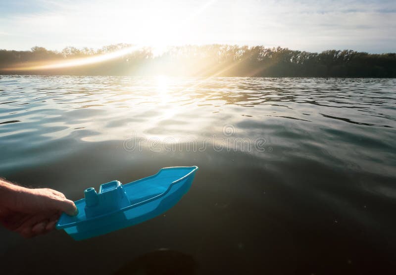 Man S Hand Launches a Toy Boat into Big River Stock Image - Image of ...