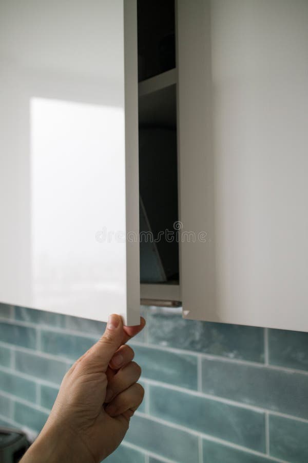 The Man`s Hand is Opened by a Modern Hanging Cabinet for a Kitchen ...