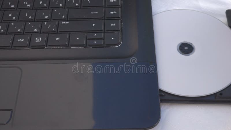 A Man S Hand Opens the Computer S Drive and Inserts the Disk. Stock ...