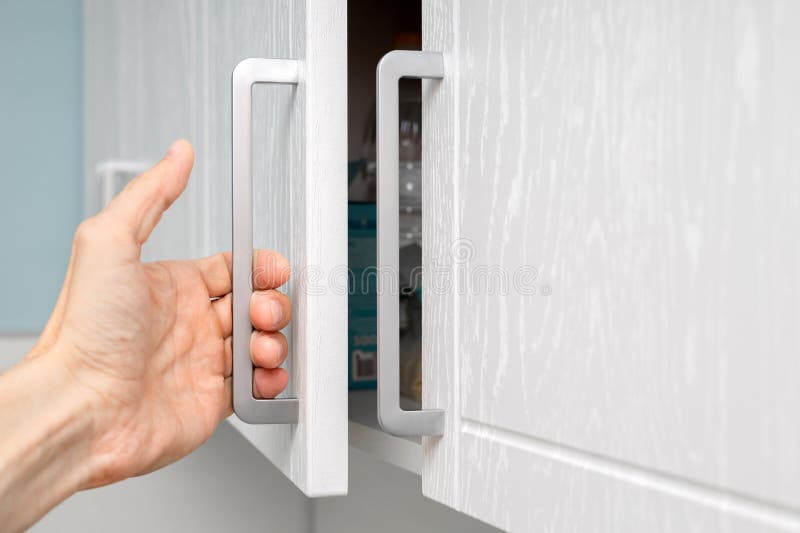 A Man& X27;s Hand Opens the Kitchen Cabinet Door Stock Image - Image of ...