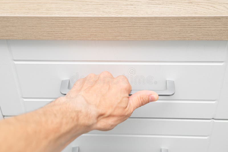 Man& X27;s Hand Opens a Kitchen Cabinet Drawer Stock Image - Image of ...