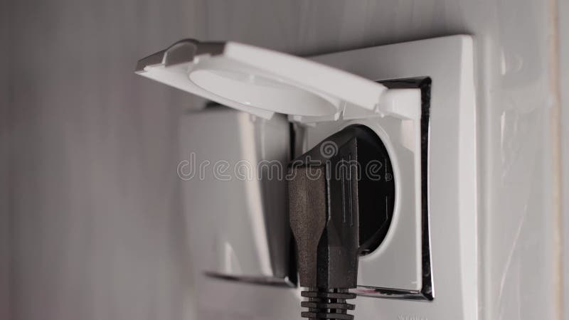 The Man S Hand Opens the Protective Cover in the Socket and Inserts a ...