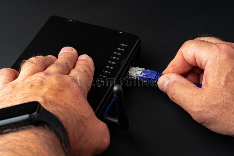 Man& X27;s Hand Plugging Internet Cable into Wifi Router Stock Photo ...