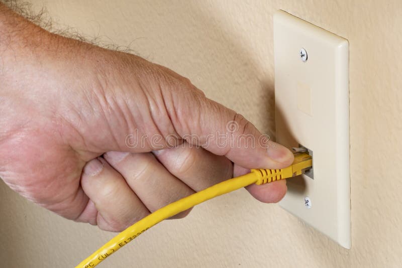 Man& X27;s Hand Plugging Yellow Ethernet Cable RJ45 into Home Network ...