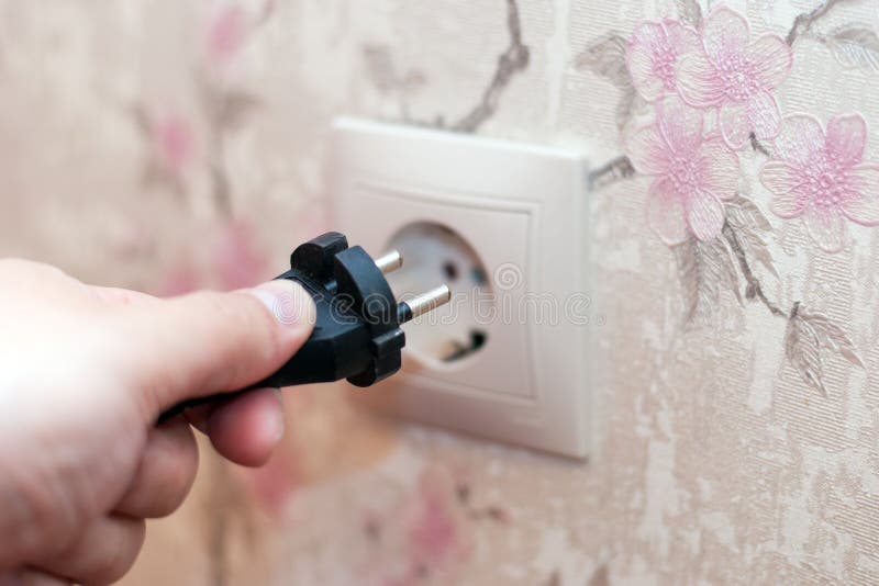 A Man Hand Plugs the Cord into a Power Outlet Stock Image - Image of ...