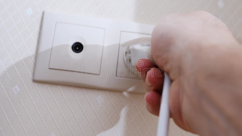 A Man S Hand Plugs an Electrical Plug into a Socket. Stock Footage ...