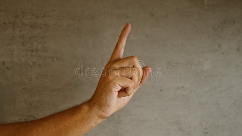 Man S Hand Pointing Upwards Against Concrete Background, Emphasizing a ...