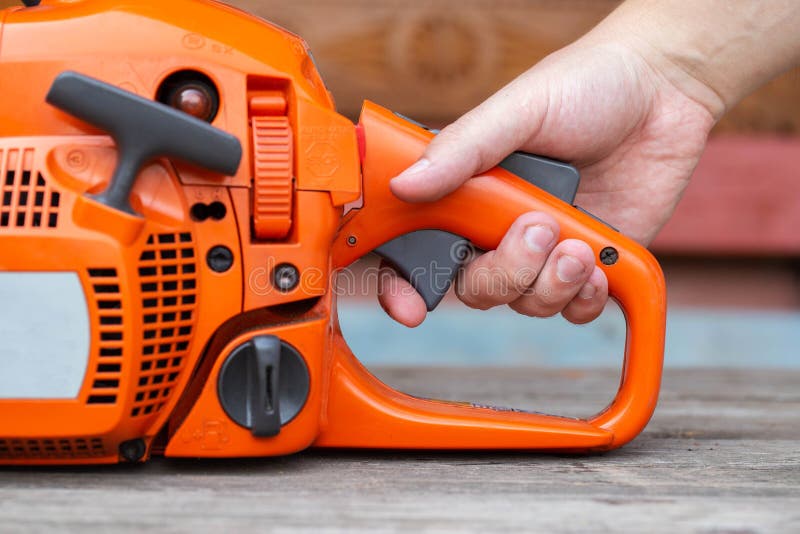 The Man`s Hand Presses the Gas Button in the Chainsaw. the Concept of ...
