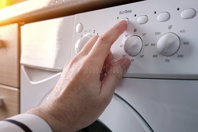 A Man S Hand Pressing the Button for Selecting the Economical Washing ...