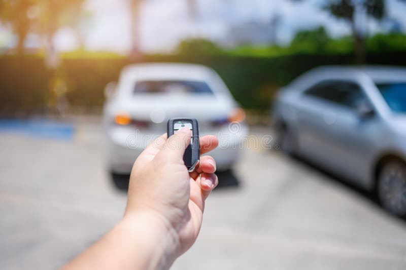 A Man S Hand is Pressing the Remote To Lock or Unlock the Door Stock ...