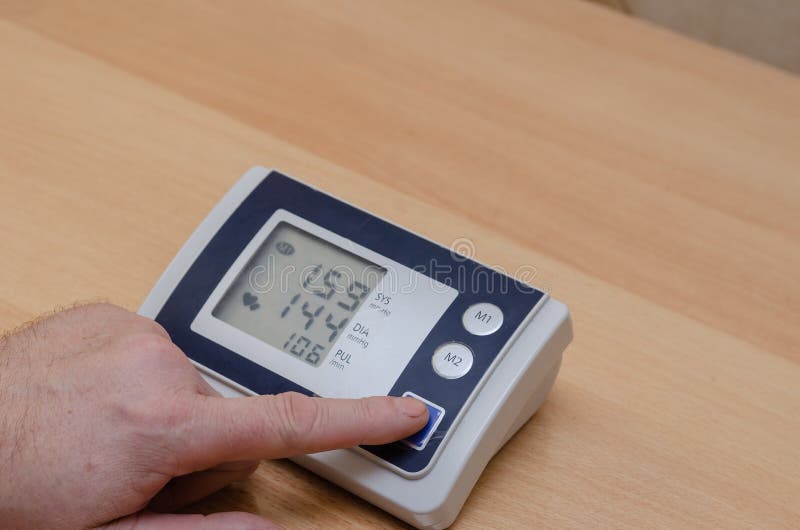 The Man`s Hand Pushes the Button of the Digital Blood Pressure M Stock ... The Man`s Hand Pushes the Button of the Digital Blood Pressure M Stock ...
