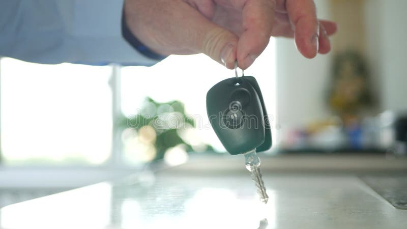 Man`s Hand Putting Some Car Keys with Remote Control on the Table Stock ...
