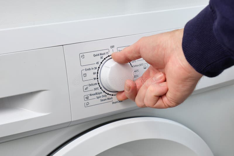 A Man S Hand Sets the Automatic Washing Program Switch on the Washing ...