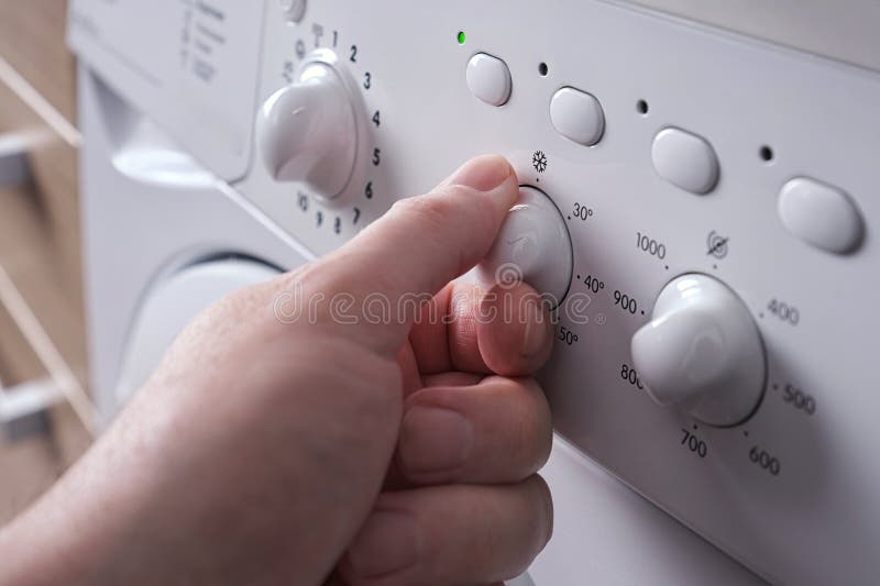 A Man S Hand Sets the Washing Mode Temperature Switch on the Washing ...
