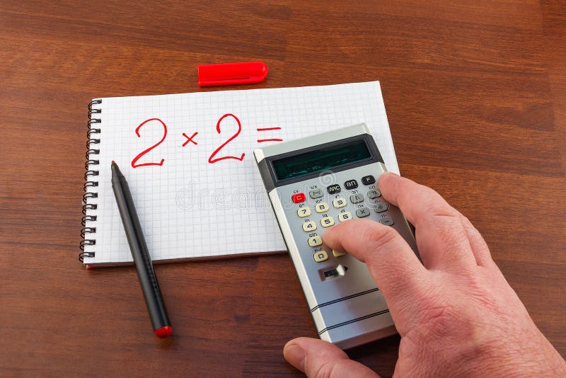 Man`s Hand Solves the Equation Written on Notebook Sheet in a Ca Stock ...