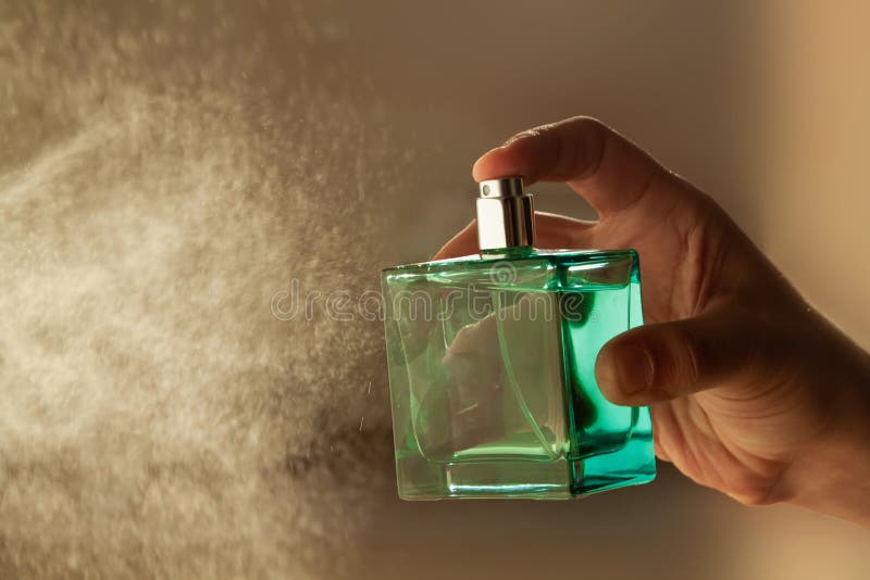 Man& X27;s Hand Spraying Luxury Perfume on a Light Background. Stock ...