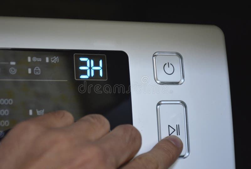 Man& X27;s Hand on the Start Button of the Washing Machine Stock Photo ...