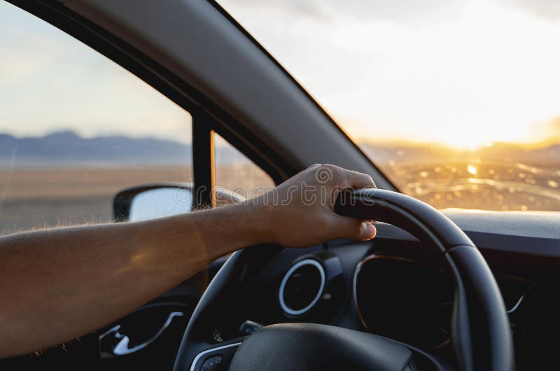 A Man S Hand on the Steering Wheel. Driving during Sunset Stock Image ...