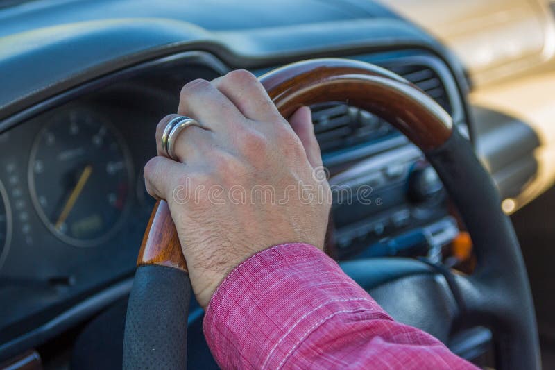 Man`s Hand on the Steering Wheel Inside of a Car Stock Image - Image of ...