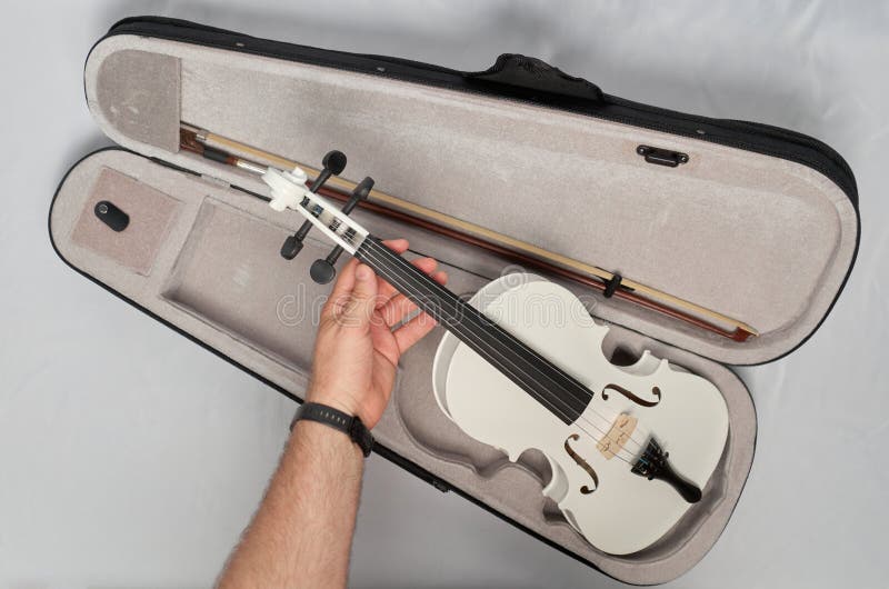 A Man S Hand Takes a White Violin Out of Its Case Stock Image - Image ...