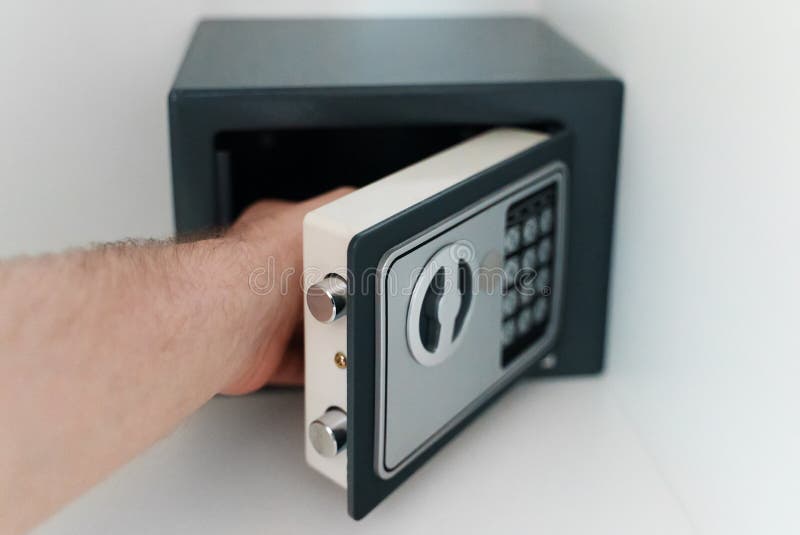 Man opening small safe stock image. Image of person - 225941807