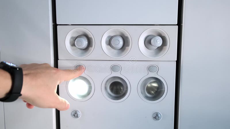 A Man S Hand Turn on the Lamp Over the Seat on Airplane Board. Light ...