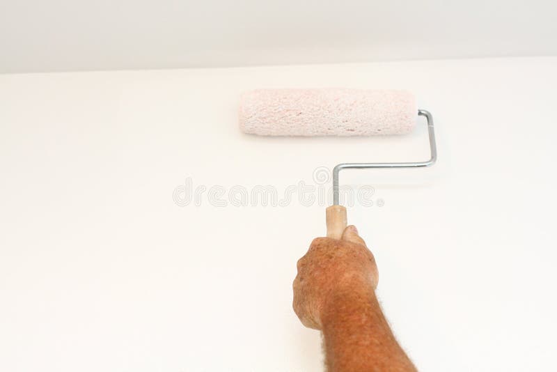 Man S Hand Using Paint Roller on White Wall Stock Photo - Image of ...