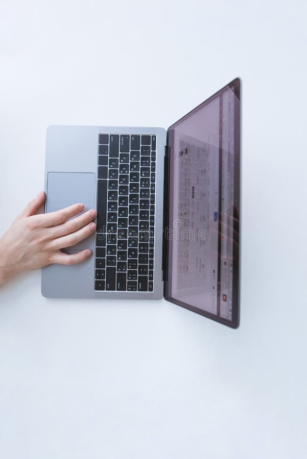 Hand Works on a Laptop on a White Table Top View. a Man Uses a Touchpad ...