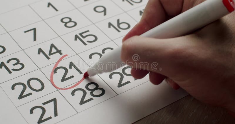Man S Hand Write Down the 21th Day on the Paper Calendar Using a Red ...