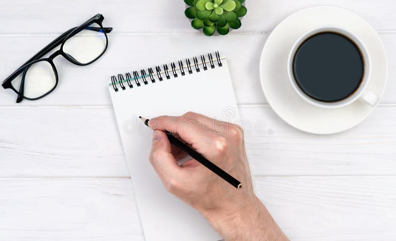 A Man S Hand Writes Something with a Pencil in a Notepad. Workplace ...