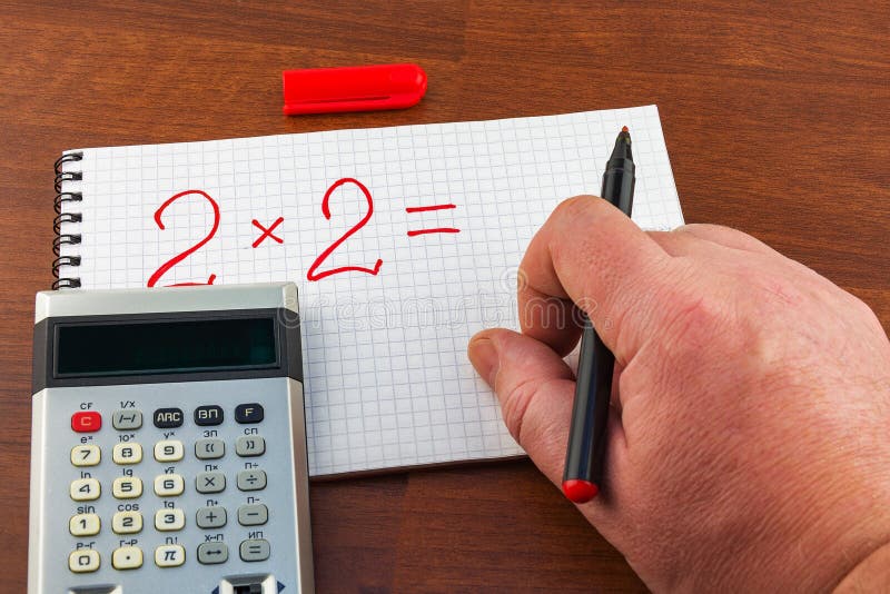 Man`s Hand Writing Equation on the Notebook Sheet in a Cage Stock Photo ...