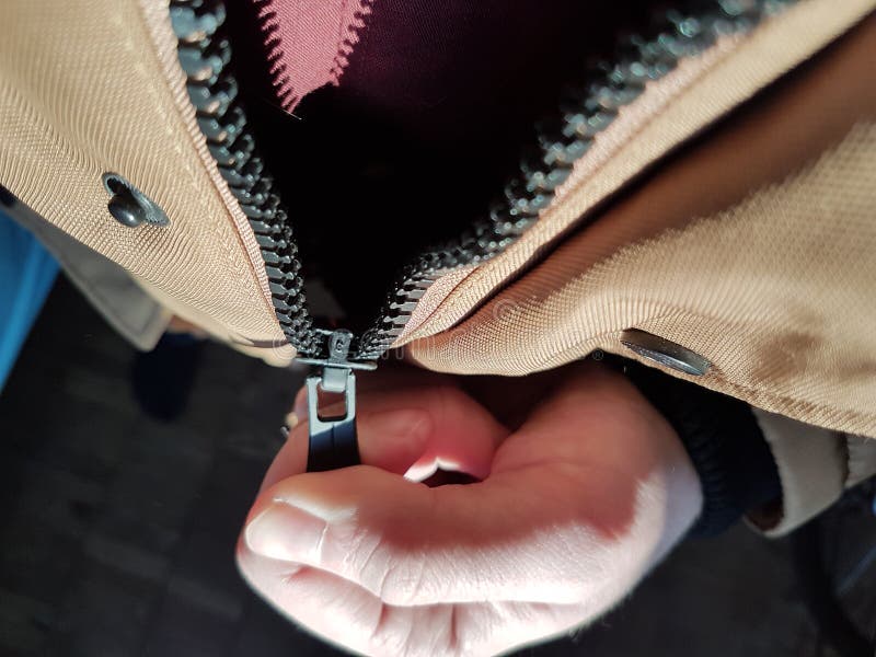 The Man`s Hand Zips Zip Up on the Jacket. Zipper Close Up in Hard Light ...