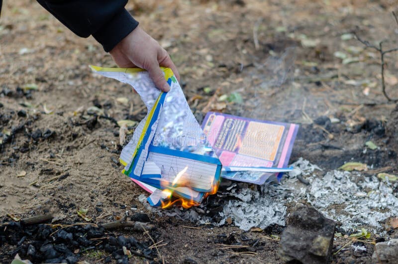 The Man`s Hands Burn a Notebook with Handwritten Text. the Man P Stock ...