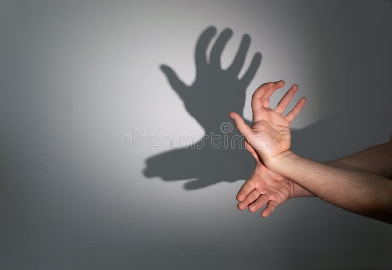 A Man`s Hands Folded in a Gesture Giving Shadow in the Form of a Moose ...