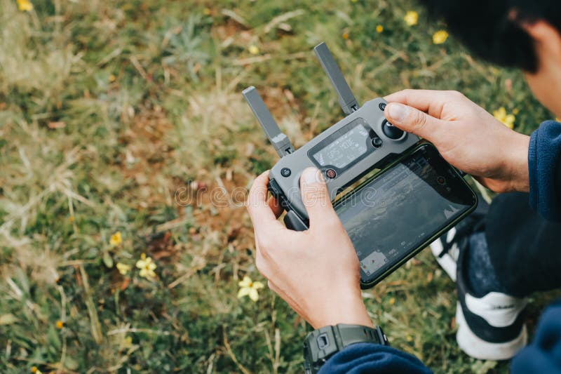 Man S Hands Holding the Remote Control of a Drone (Drone Operator ...